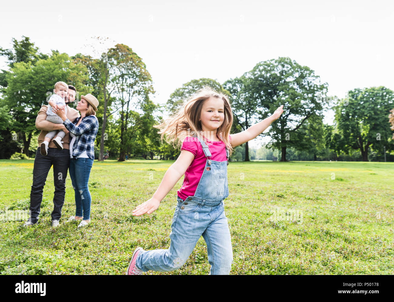 Active happy family in a park Stock Photo - Alamy
