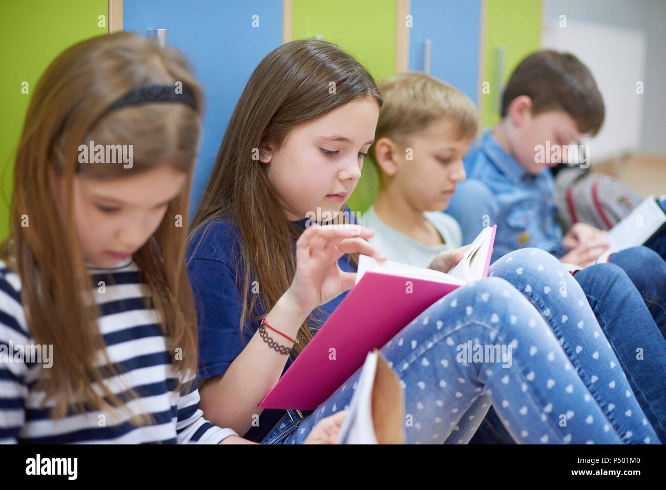 Pupils learning together on corridor in school Stock Photo - Alamy