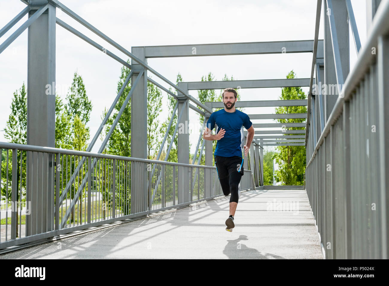 Man running on a bridge Stock Photo - Alamy