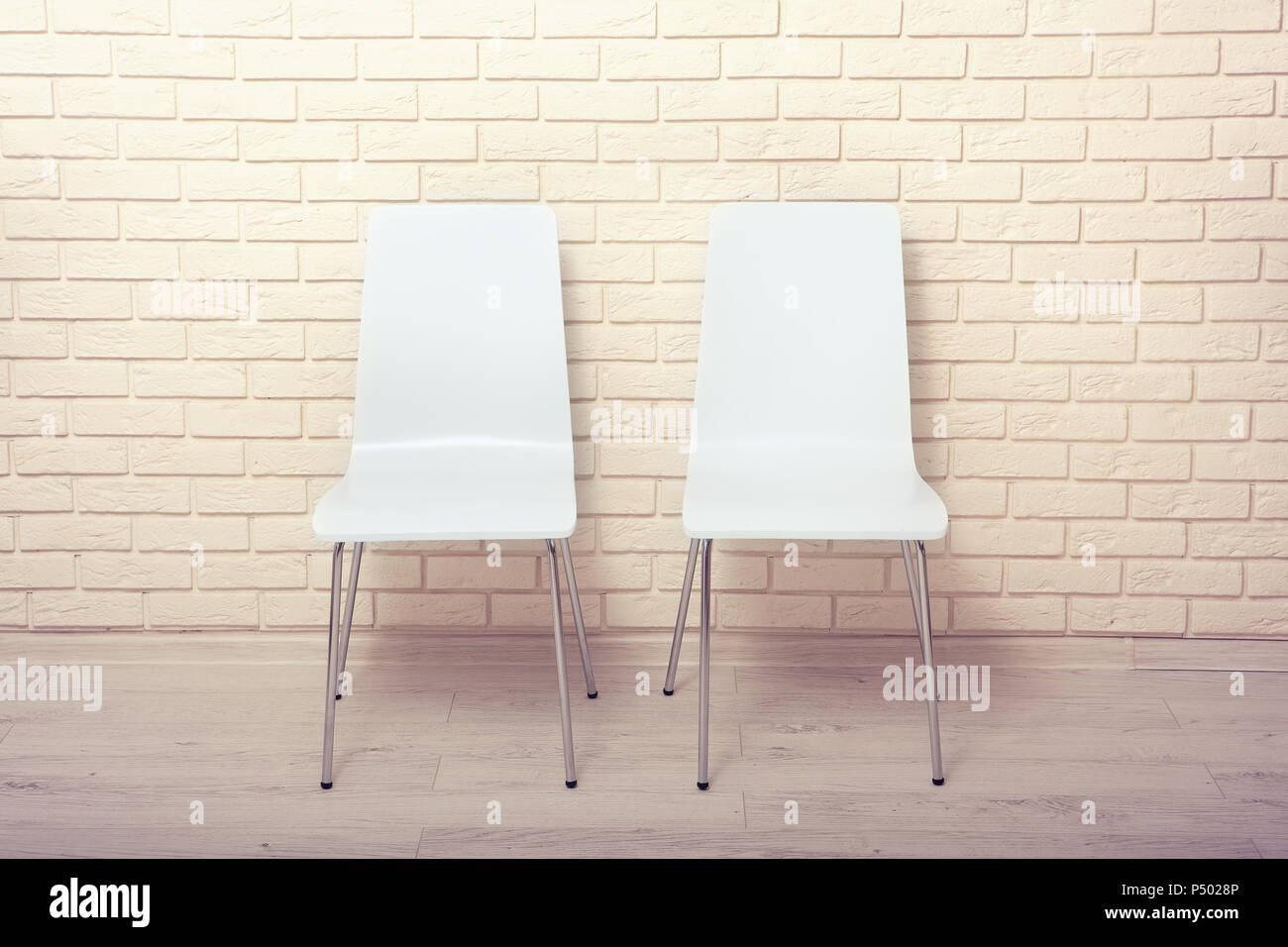 White chairs near the white wall for interior or graphic backgrounds ...