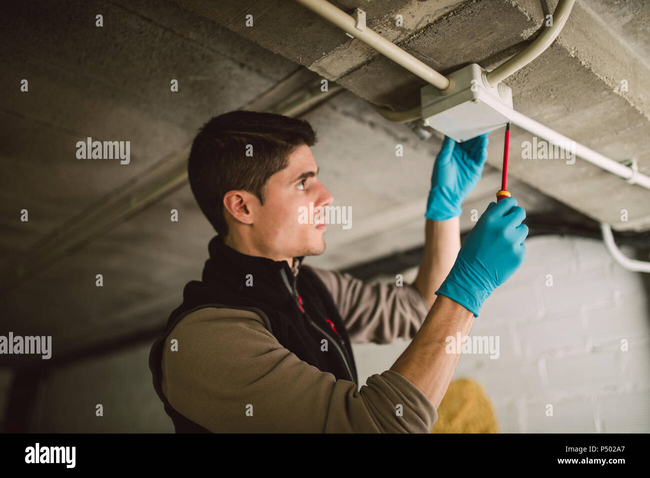 Man working on an electrical installation Stock Photo - Alamy