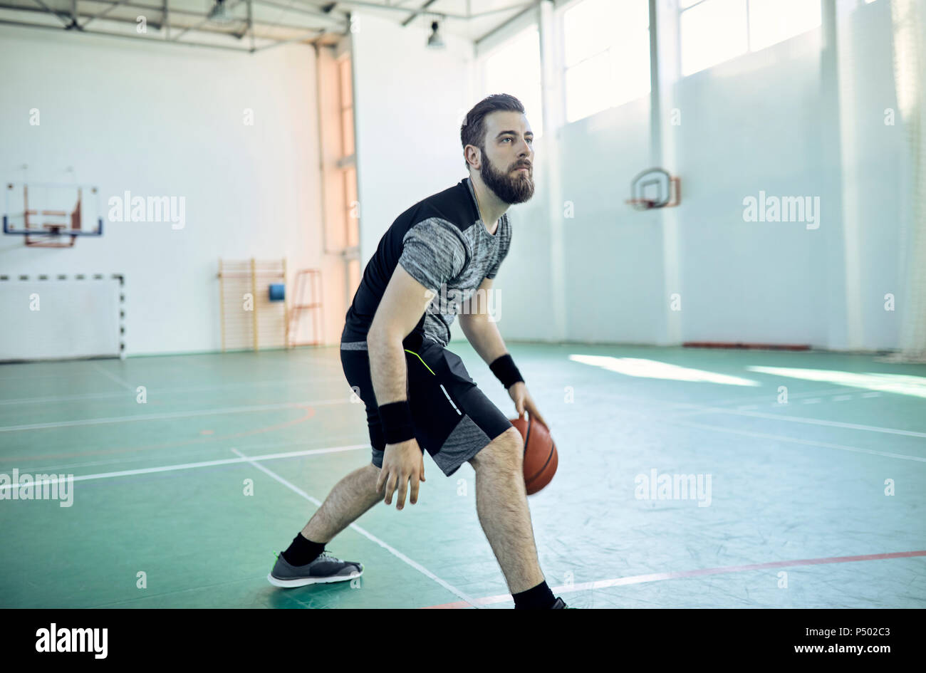 Man playing basketball, indoor Stock Photo - Alamy