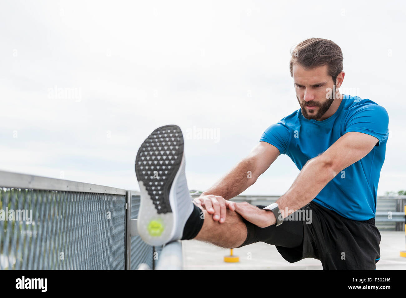 Man stetching on a parking level Stock Photo - Alamy
