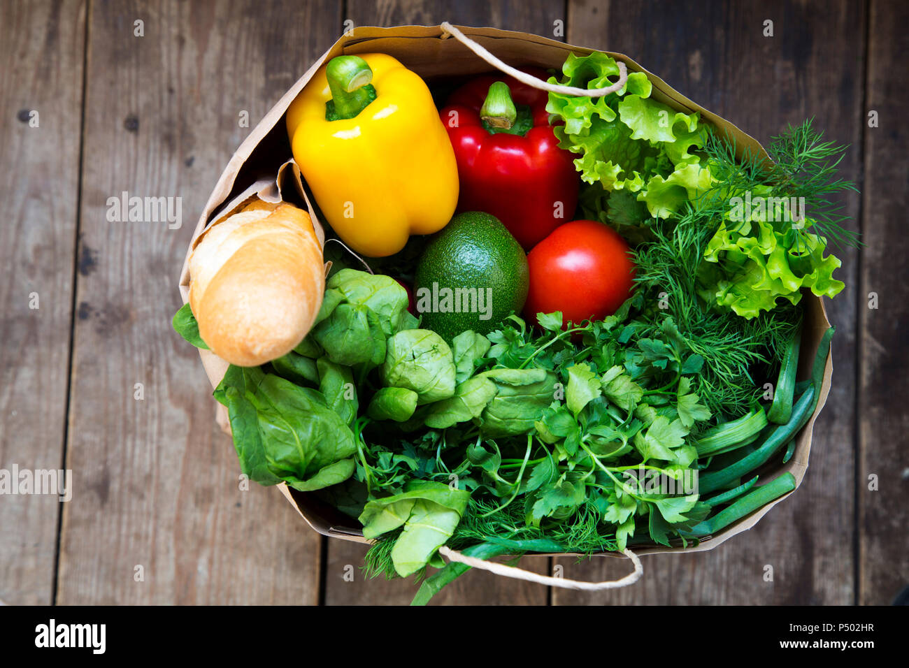 Full Paper bag of groceries on wooden background. From above. Top view ...