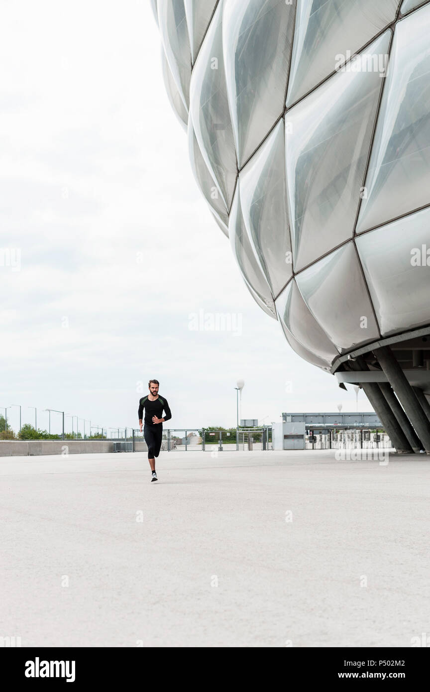 Man running at stadium Stock Photo - Alamy
