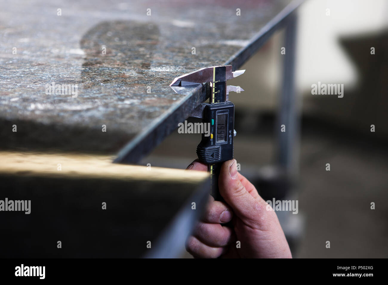 Stonemason measuring slab in his workshop Stock Photo - Alamy