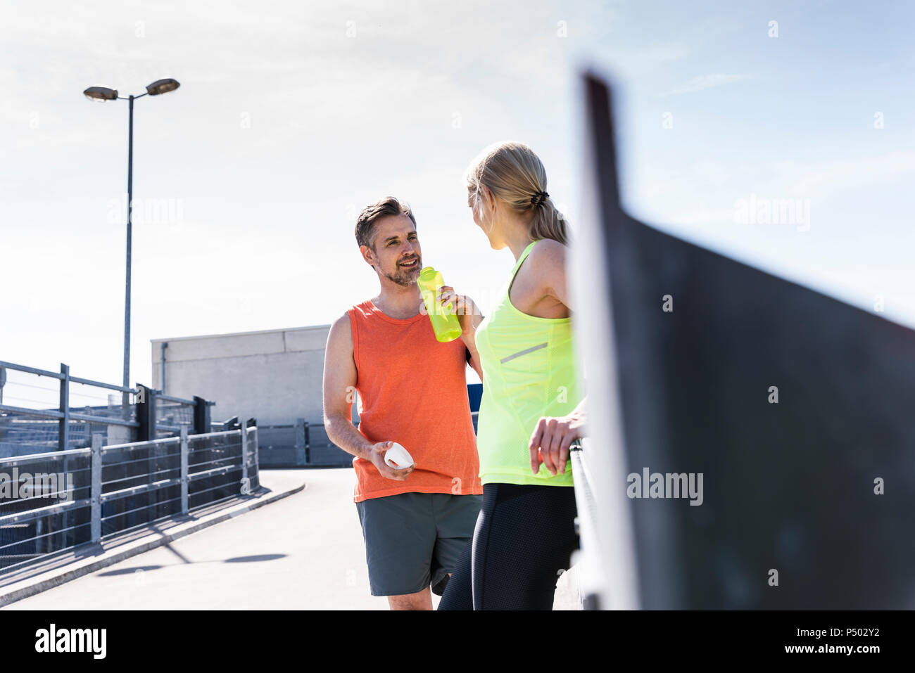 Fit couple jogging in the city, having fun, taking a break Stock Photo ...