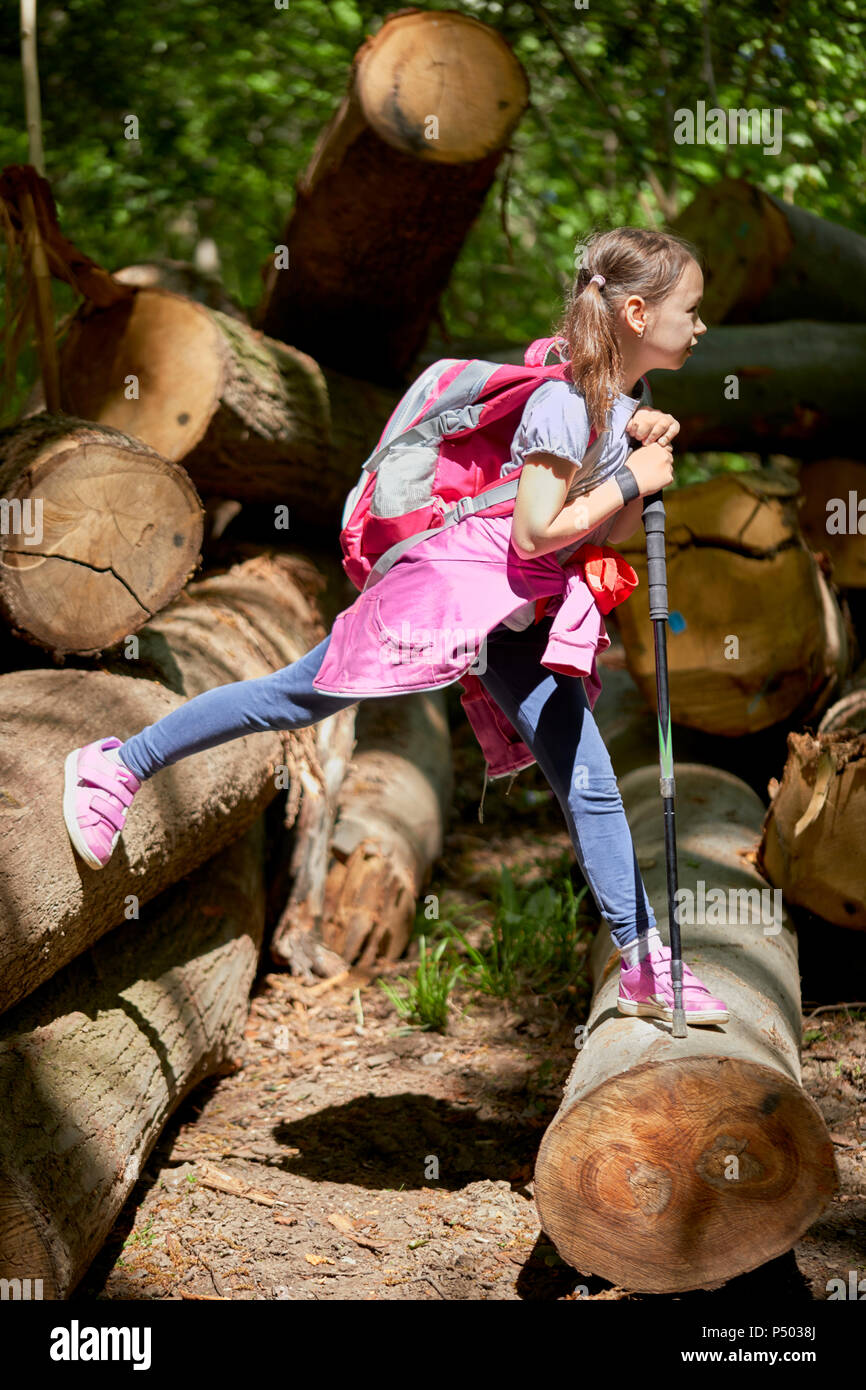 Girl balancing logs forest hi-res stock photography and images - Alamy