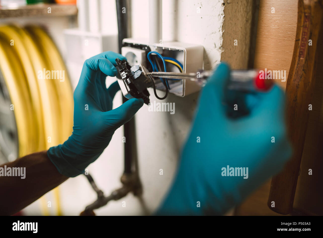 Detail of a man working on an electrical installation Stock Photo - Alamy