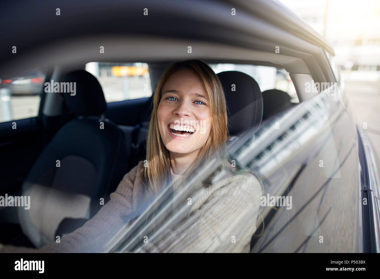 Young woman in car laughing hi-res stock photography and images - Alamy