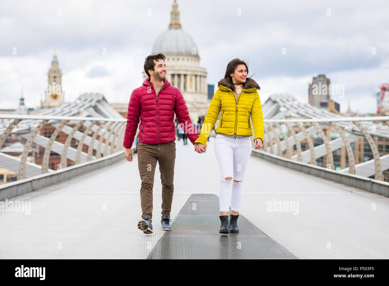 Young couple walking hand hand bridge front st pauls cathedral hi-res ...