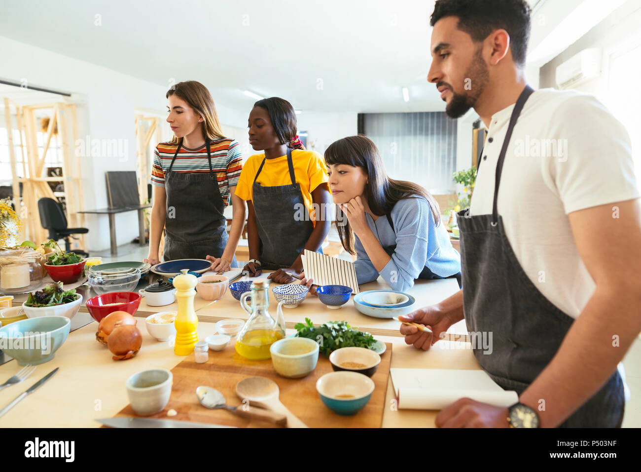 Woman watching men cook hi-res stock photography and images - Alamy