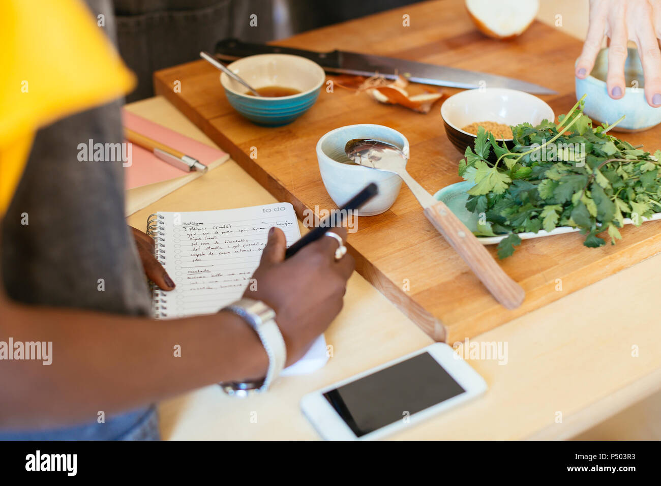 Close-up of woman taking notes in a cooking workshop Stock Photo - Alamy