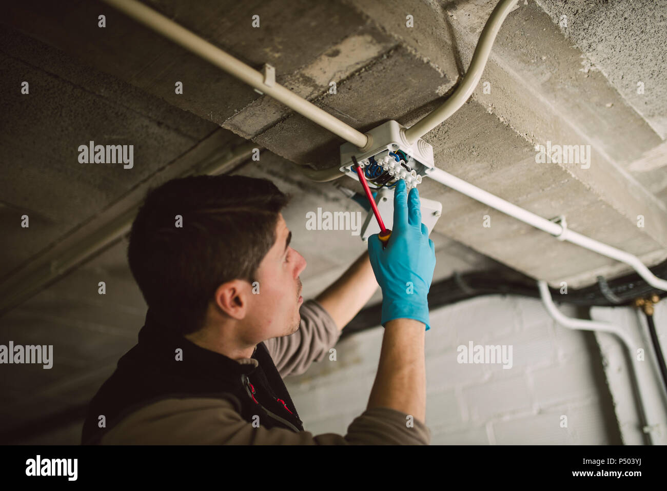Man working on an electrical installation Stock Photo - Alamy