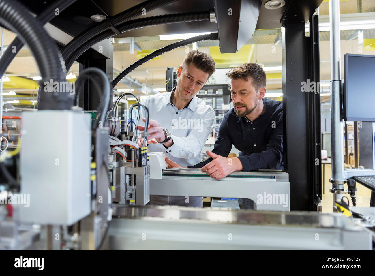 Two machine hi-res stock photography and images - Alamy