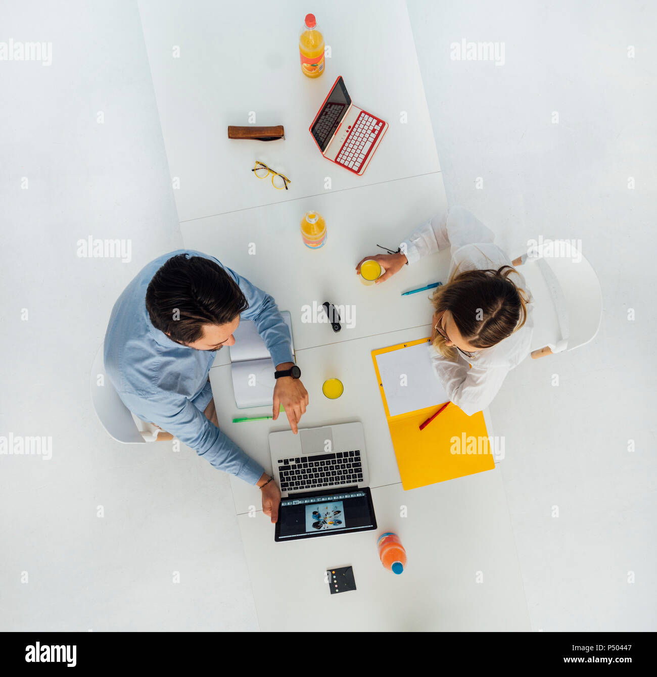 Two business people at meeting table in office, top view Stock Photo ...