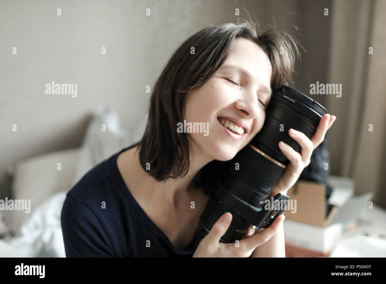 Woman enjoying her new lens Stock Photo - Alamy