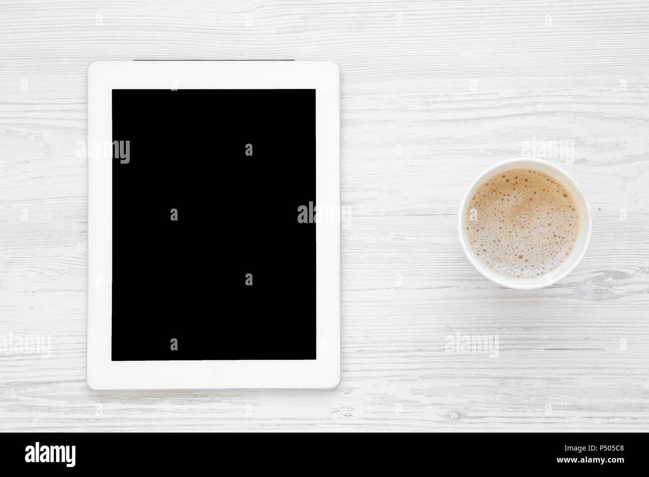 Minimal work space with tablet and latte on white wooden background ...