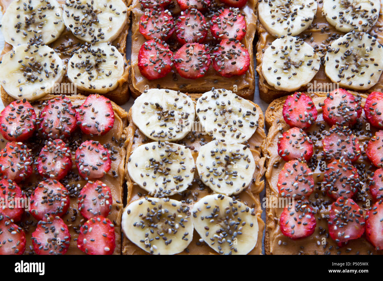 Vegan toasts with fruits, seeds, peanut butter. Clean eating. Closeup ...