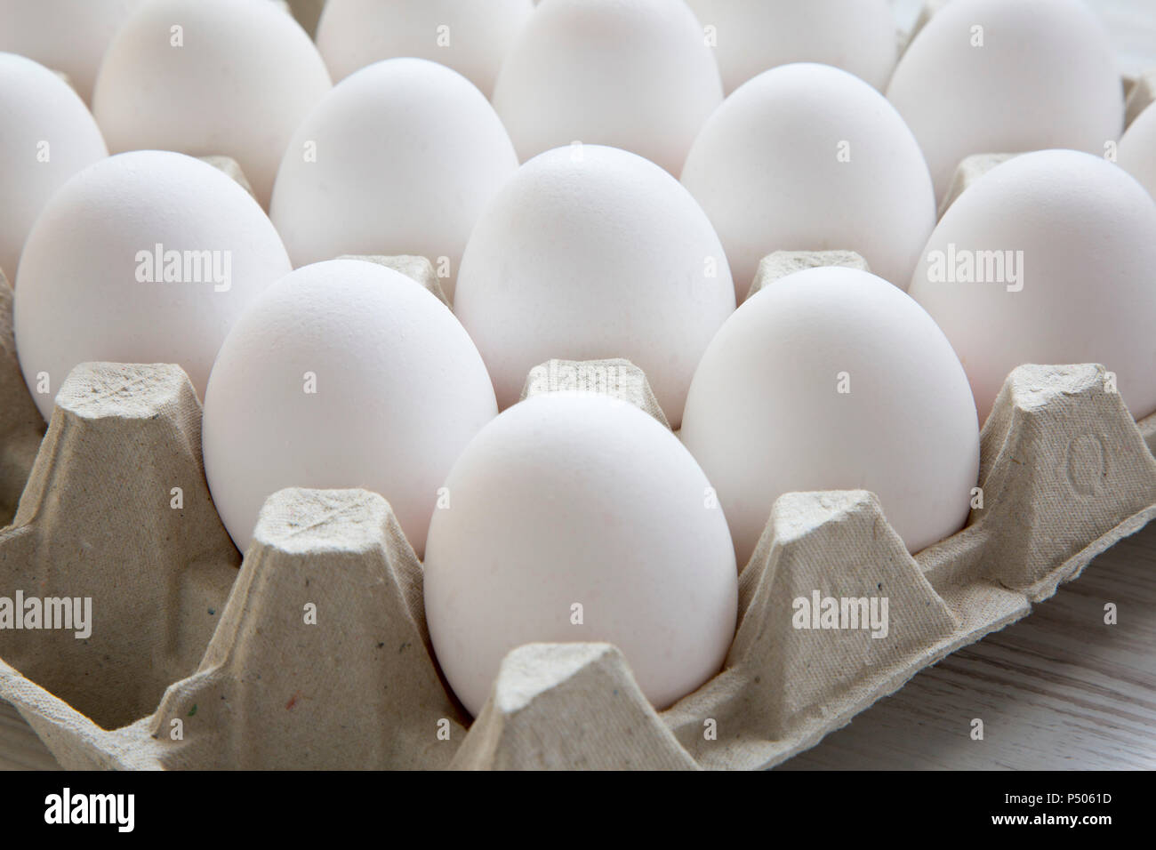 Chicken eggs in egg box, close-up. Side view Stock Photo - Alamy