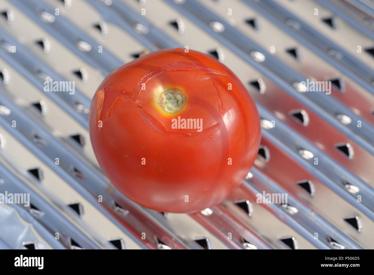 Single Tomato at a barbecue getting heated Stock Photo - Alamy