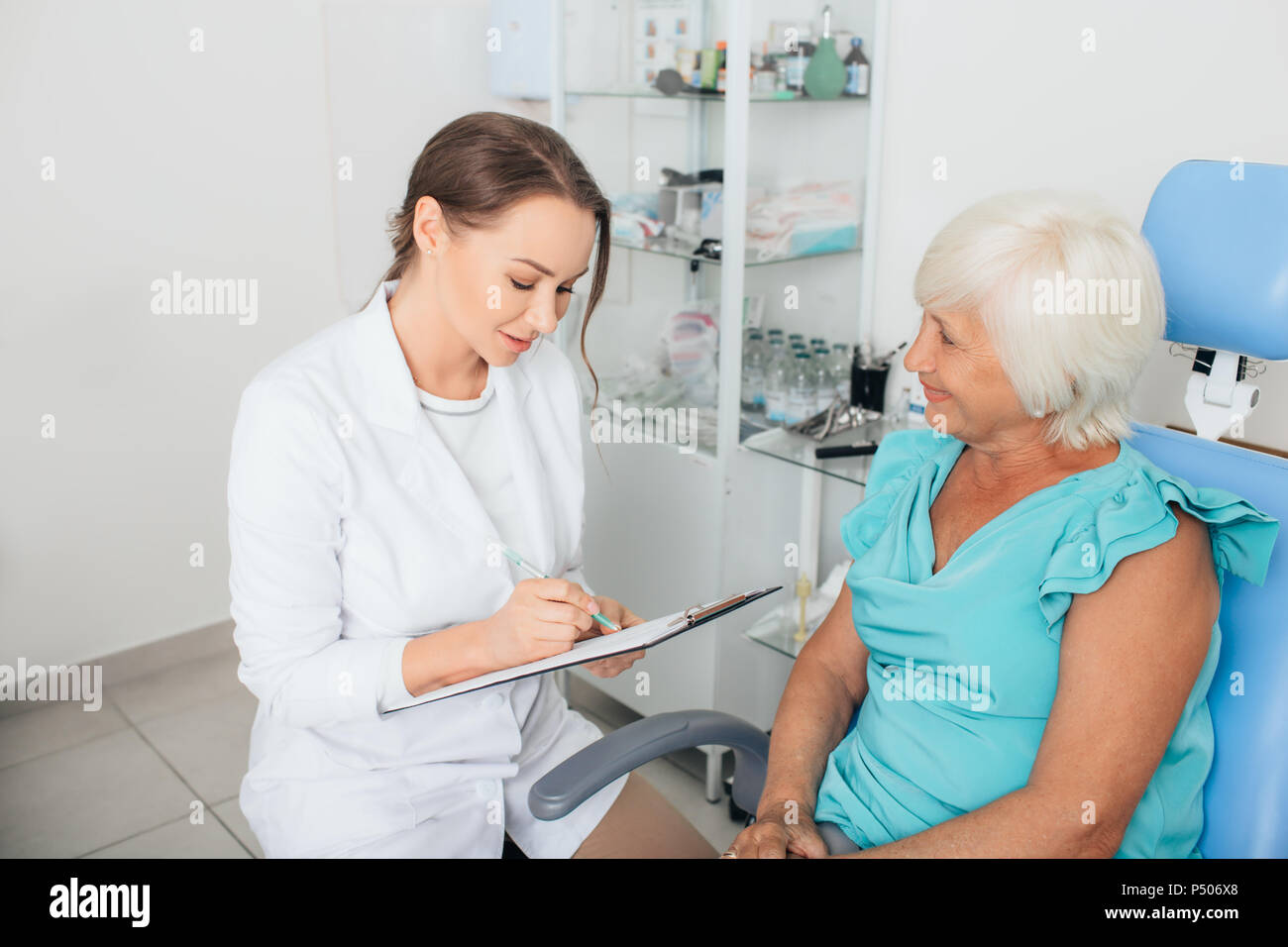 doctor and senior patient reviewing medical chart Stock Photo - Alamy