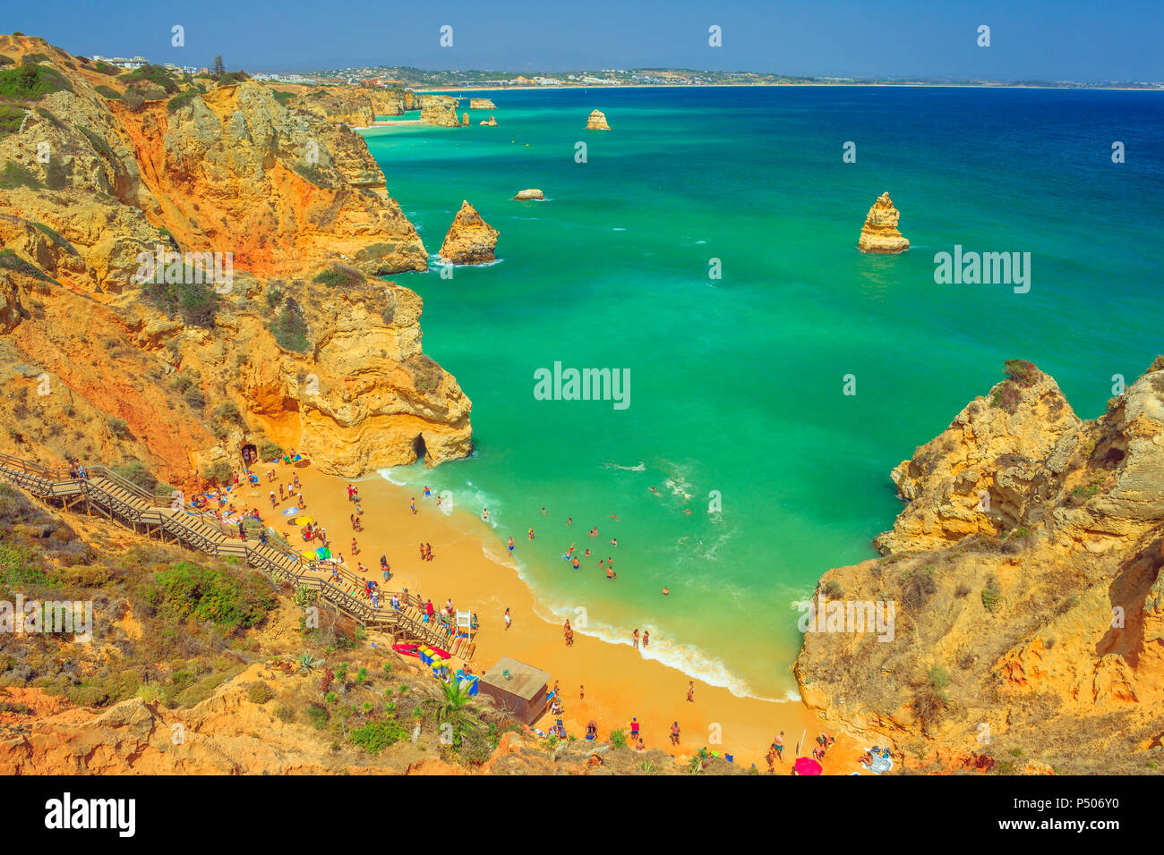 Aerial view of Praia do Camilo with long steps in Algarve, Portugal ...