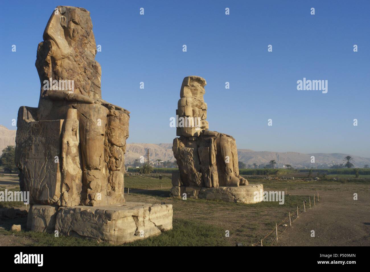 Colossi of Memnon. Stone statues depicting pharaoh Amenhotep III (14th ...
