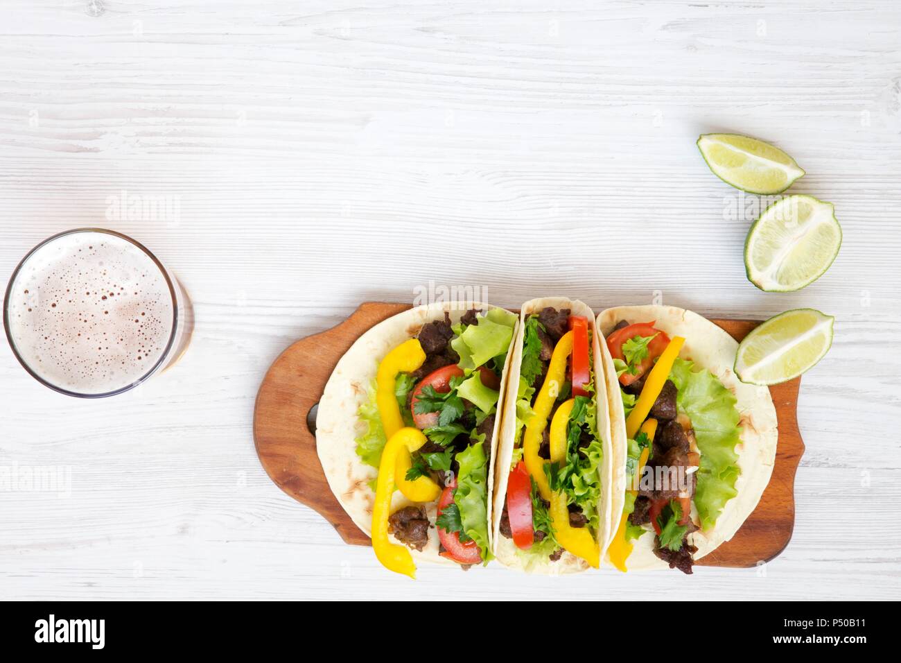 Beef taco on the board with vegetables and beer. Top view Stock Photo ...