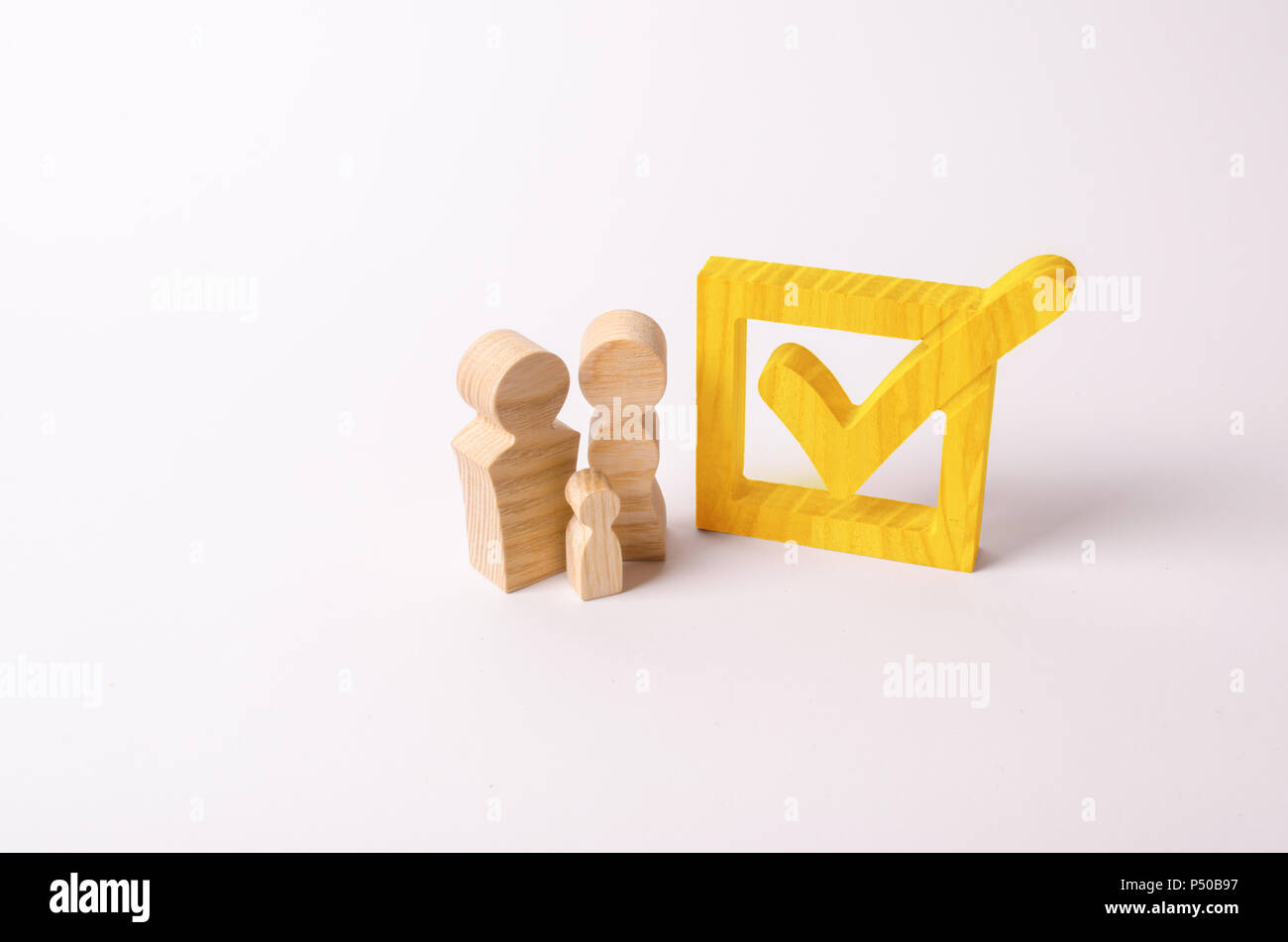 Wooden figures of people stand near the tick in the box. Checkbox ...