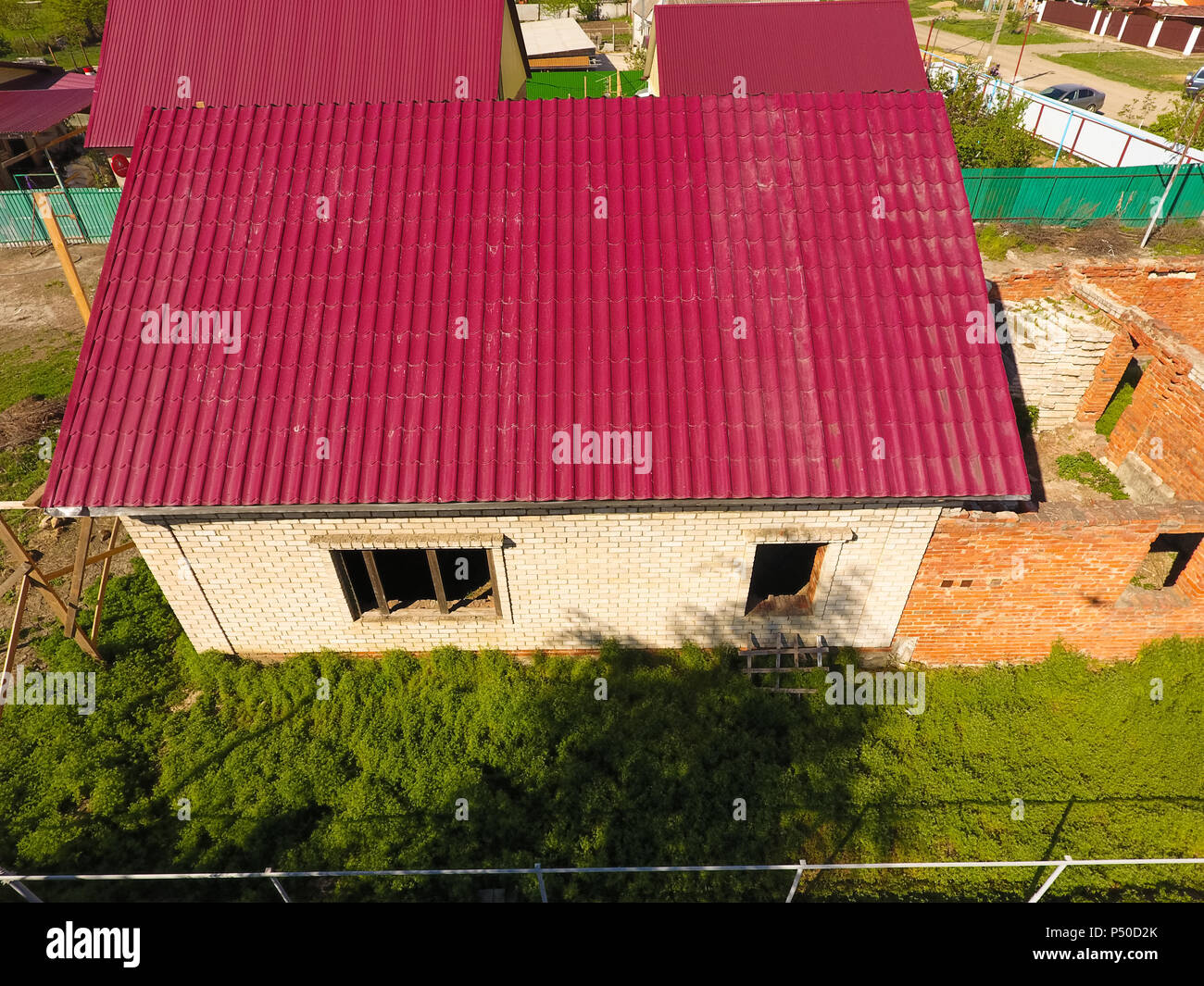 A house with a red roof made of corrugated metal sheets. Roof from ...