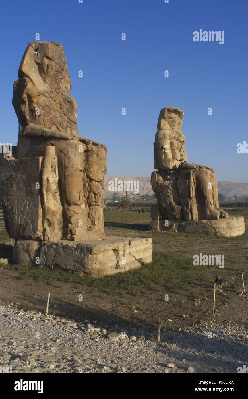 Colossi of Memnon. Stone statues depicting pharaoh Amenhotep III (14th ...