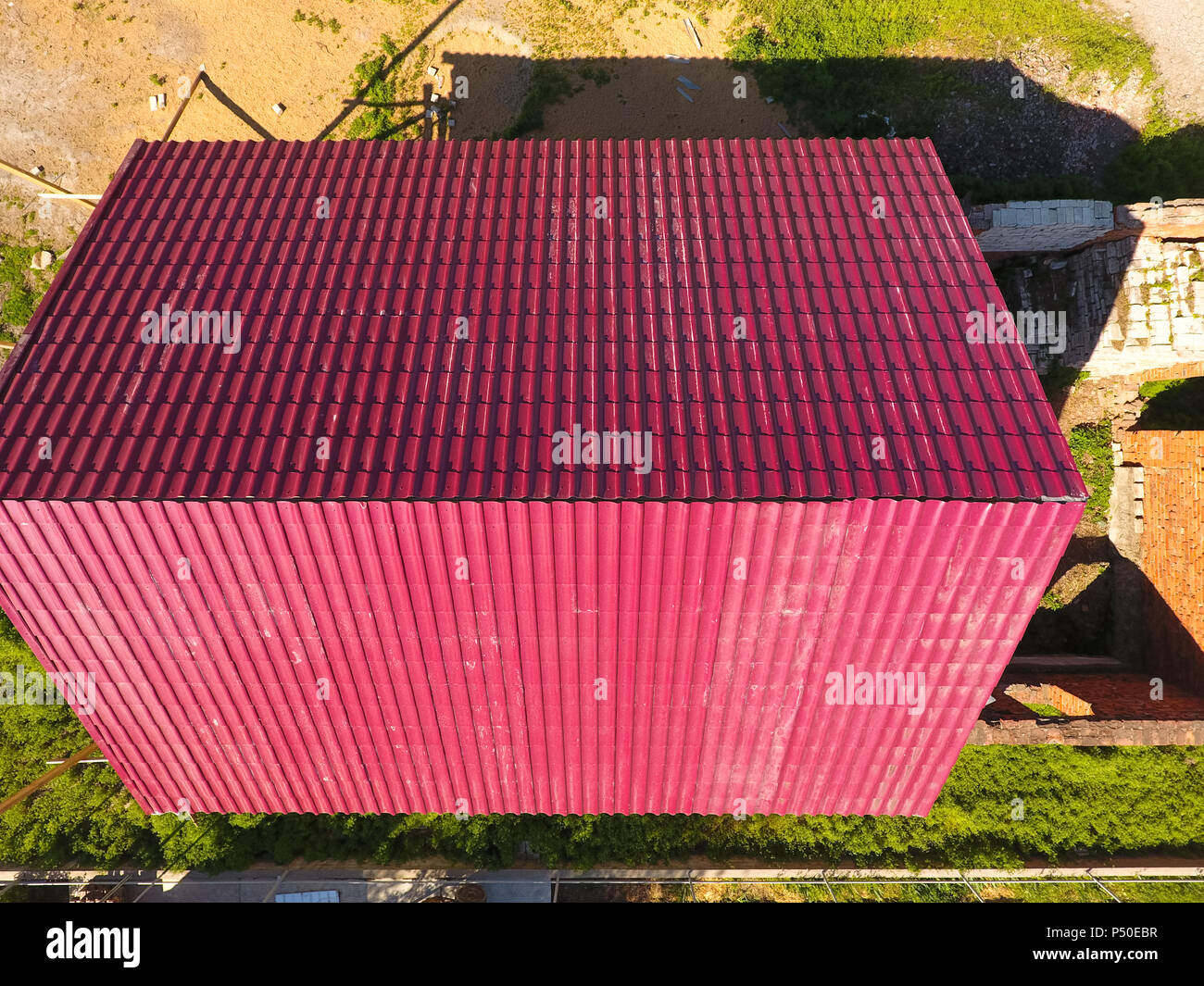 A house with a red roof made of corrugated metal sheets. Roof from ...