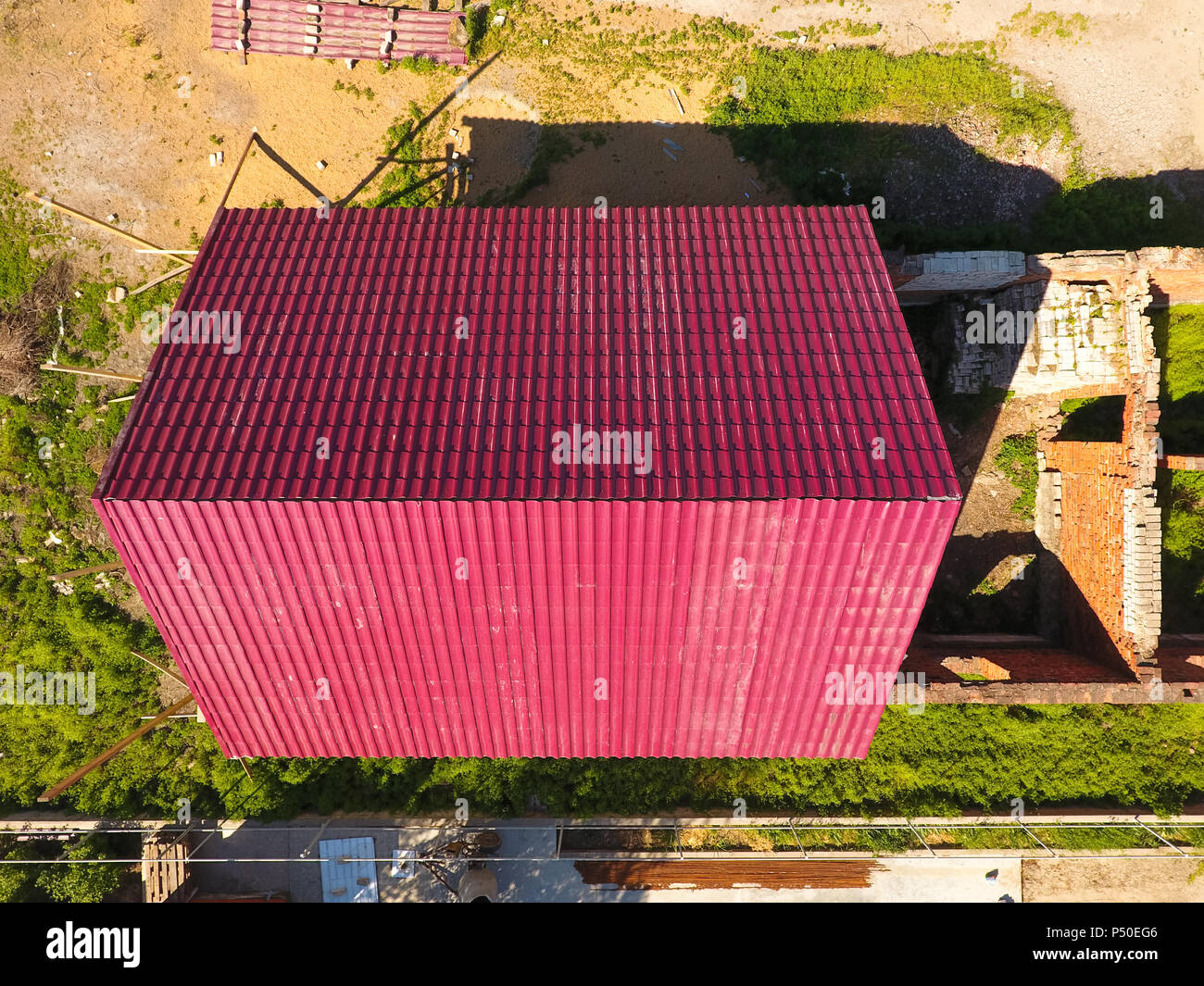 A house with a red roof made of corrugated metal sheets. Roof from ...