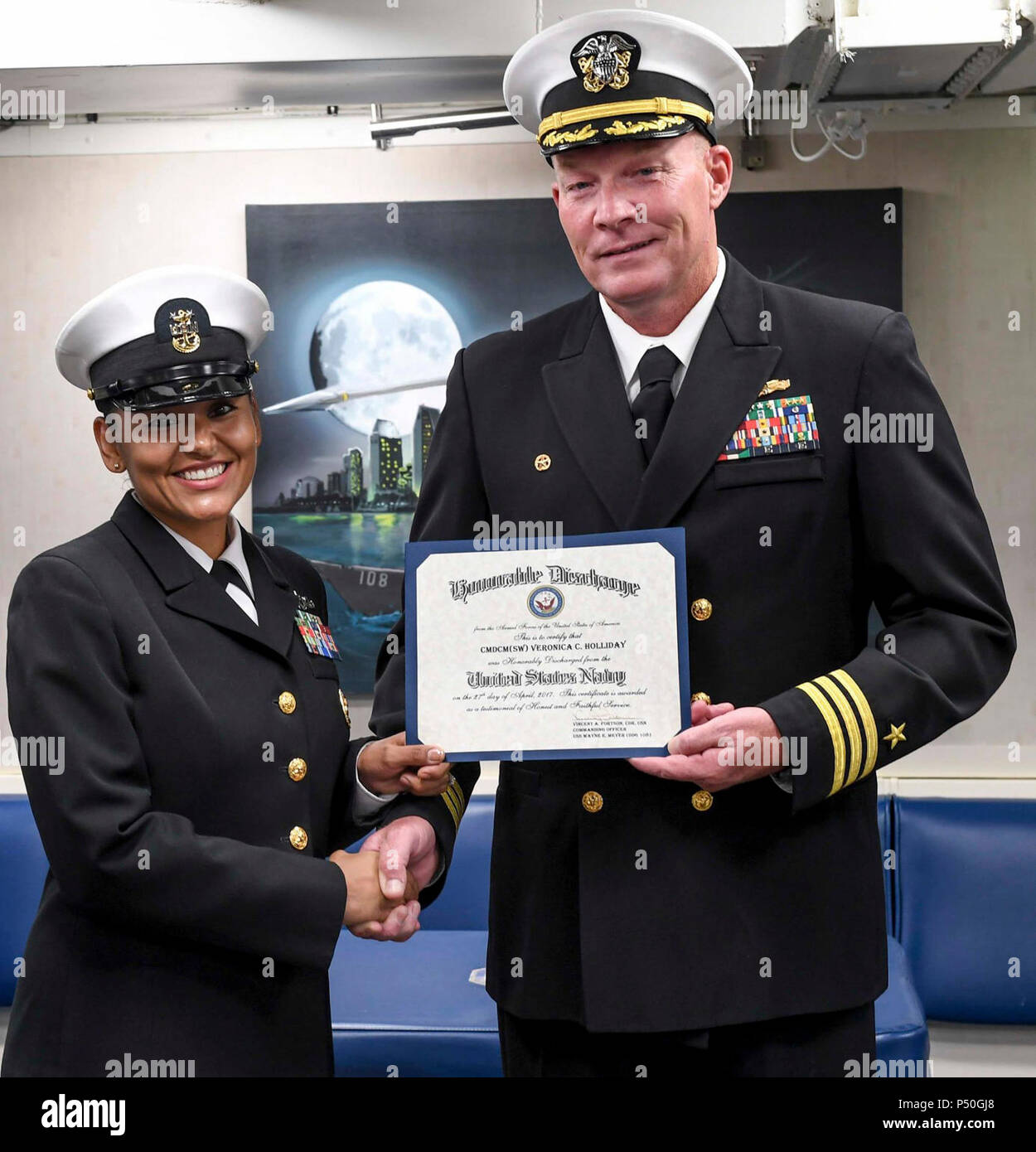 170427 - CAPT Fortson gives CMDCM Holliday honorable discharge ...