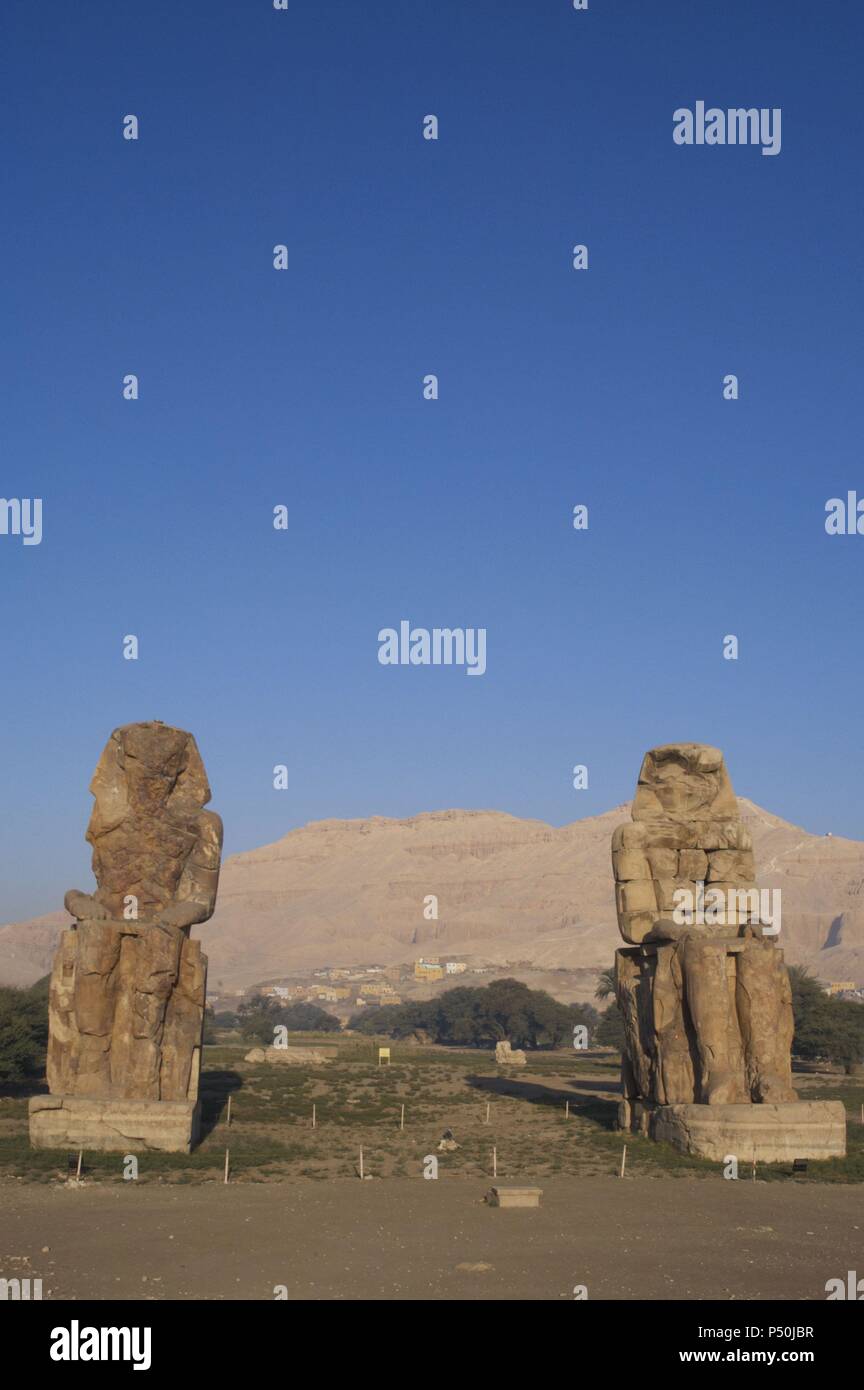 Colossi of Memnon. Stone statues depicting pharaoh Amenhotep III (14th ...
