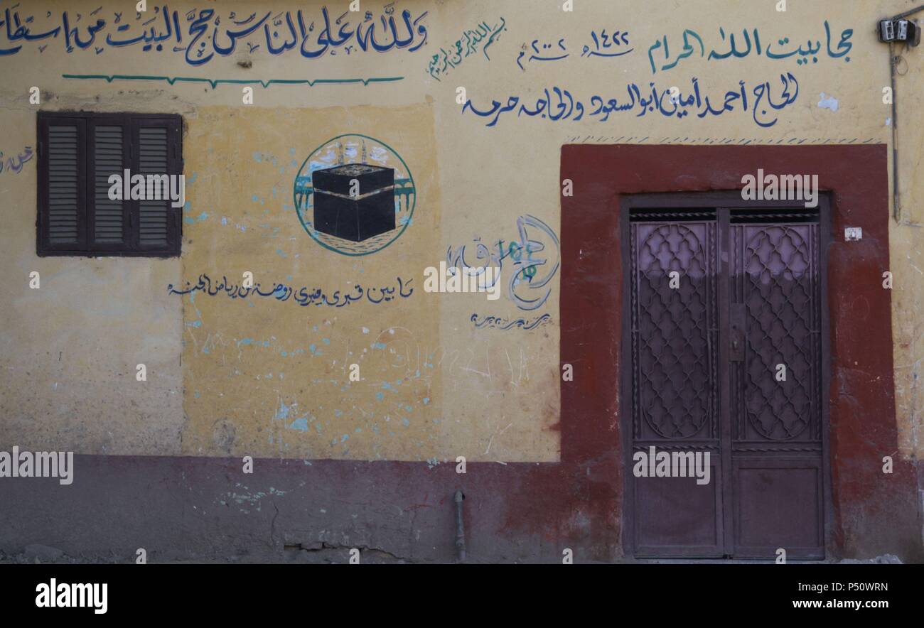 Facade of a house decorated with the holy city of Mecca. Luxor. Egypt ...