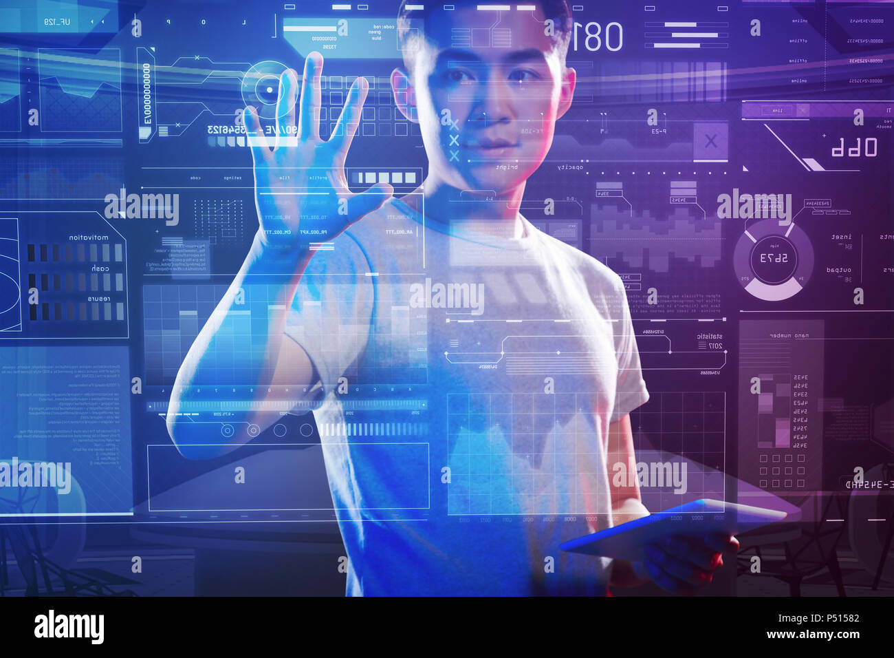 Smart web developer standing with a tablet and working with a ...