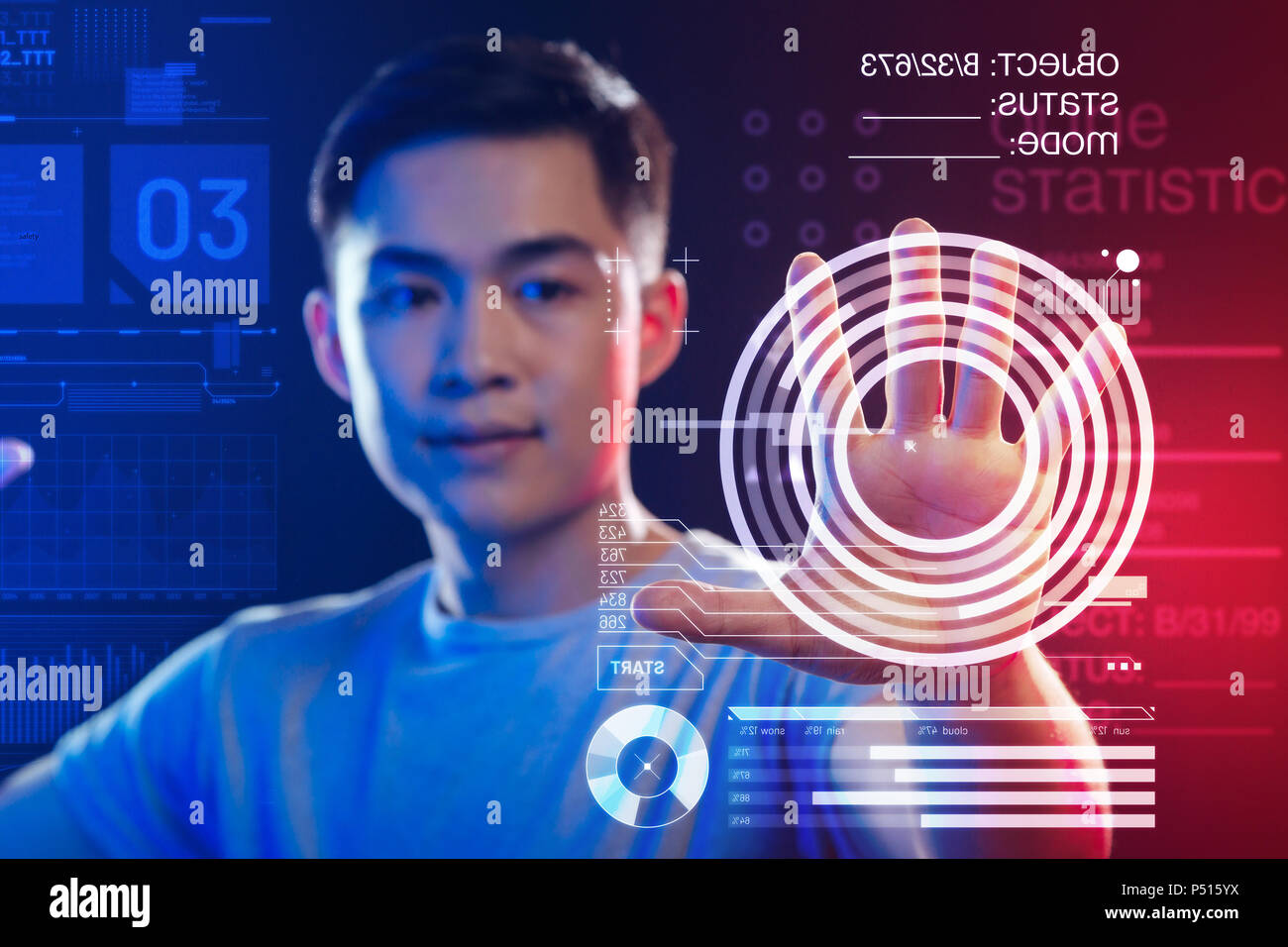 Calm young man looking at the screen while touching the diagram Stock ...