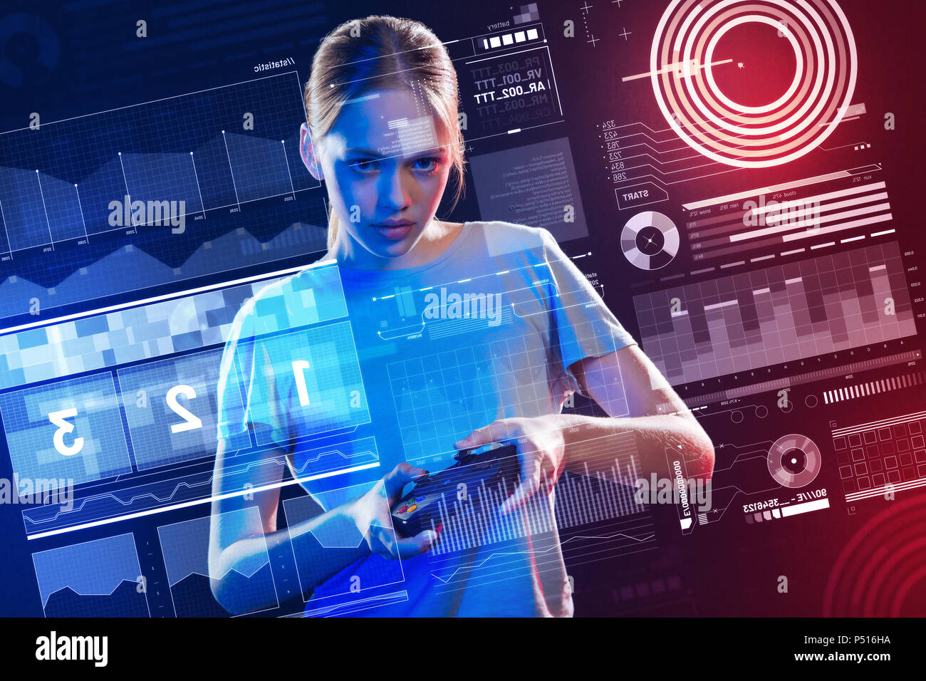 Concentrated girl holding a game console and playing video games Stock ...