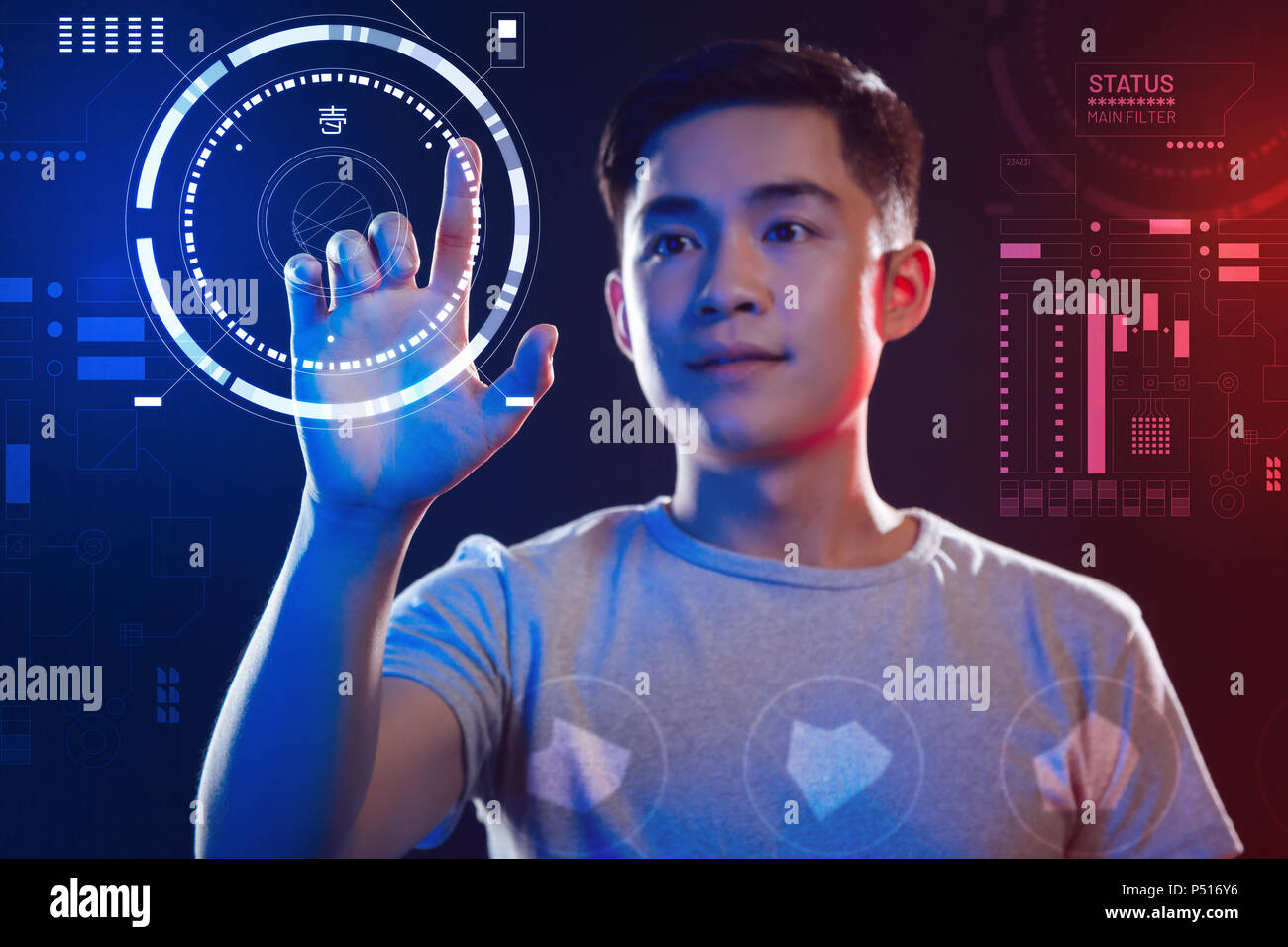 Calm young man carefully touching the screen while scanning the new ...