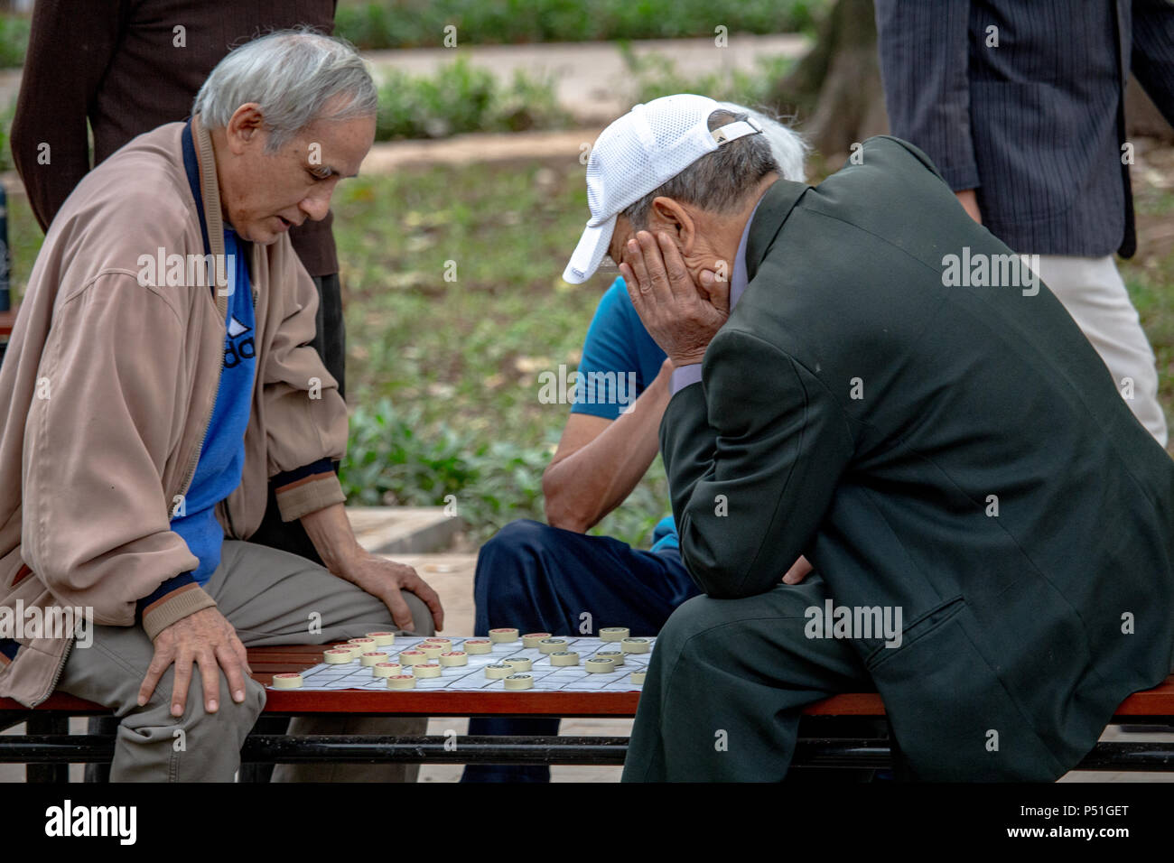 Hanoi, Vietnam - March 16, 2018: Retired elderly local people playing ...