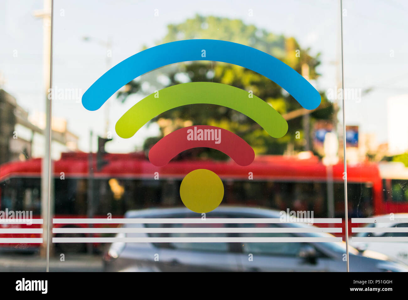 Colorful WI-FI zone sign with cars and bus in background. Sign have ...