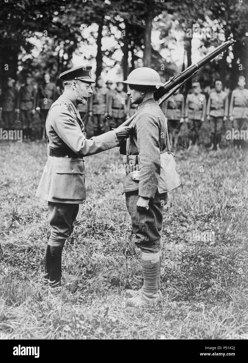 King George V of Great Britain (1865-1936) giving a medal to an ...