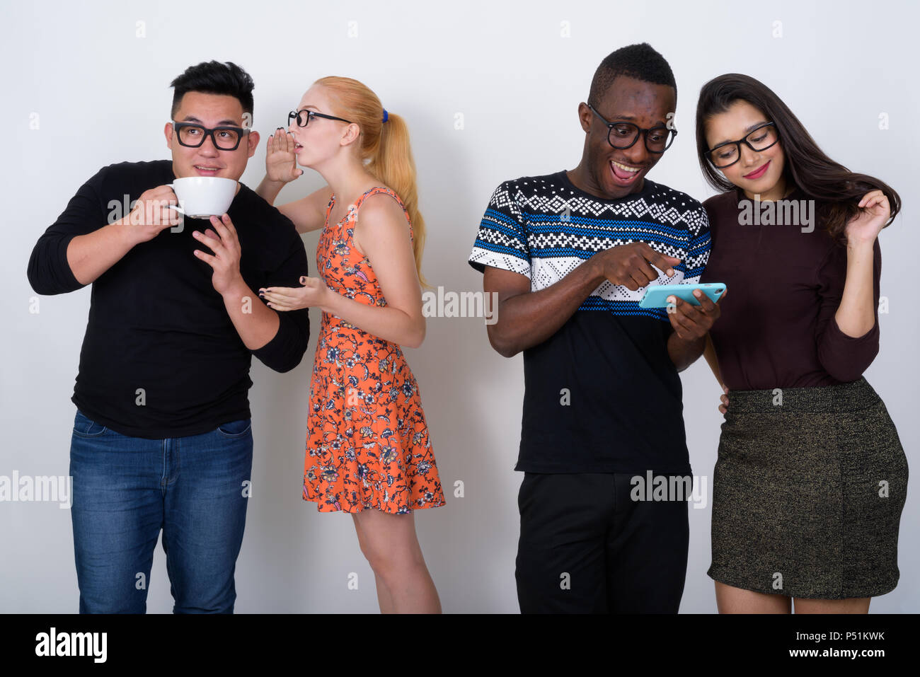 Happy diverse group of multi ethnic friends smiling while using Stock ...