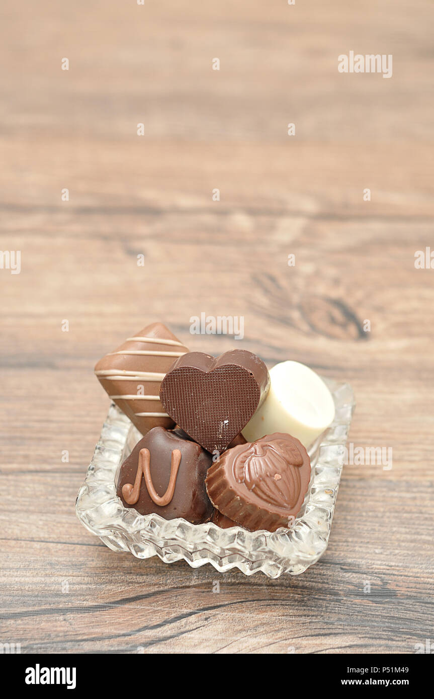 A variety of chocolates displayed in a fancy glass container Stock ...