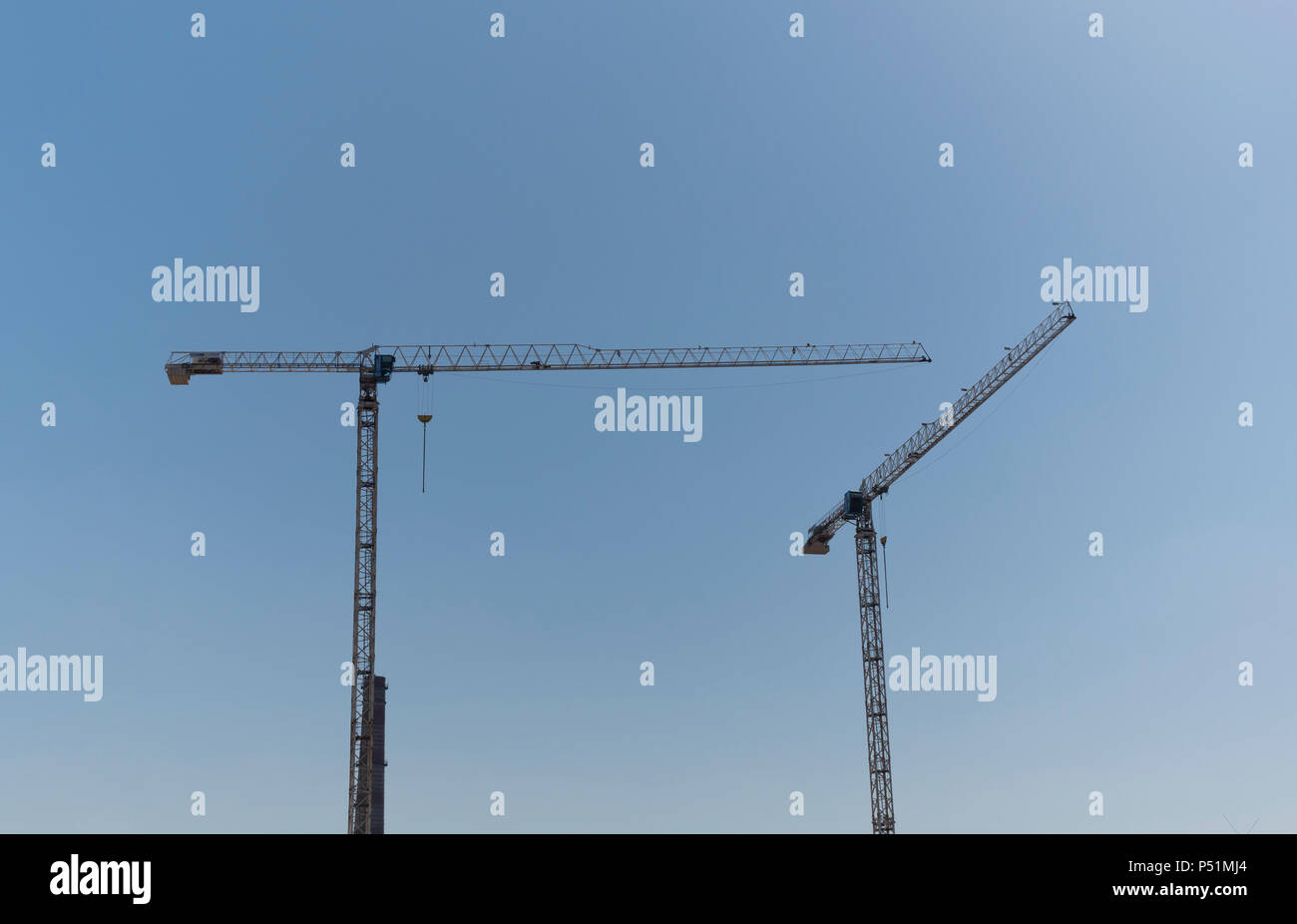 Construction site with two cranes against the sky Stock Photo - Alamy