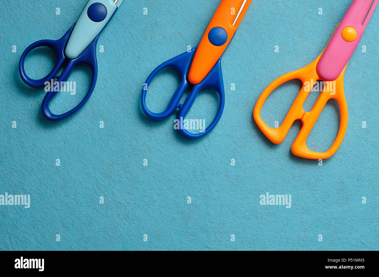 A collection of scissors on a blue background Stock Photo - Alamy