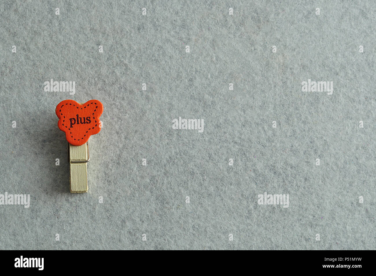 The word plus on a peg isolated on a white background Stock Photo - Alamy