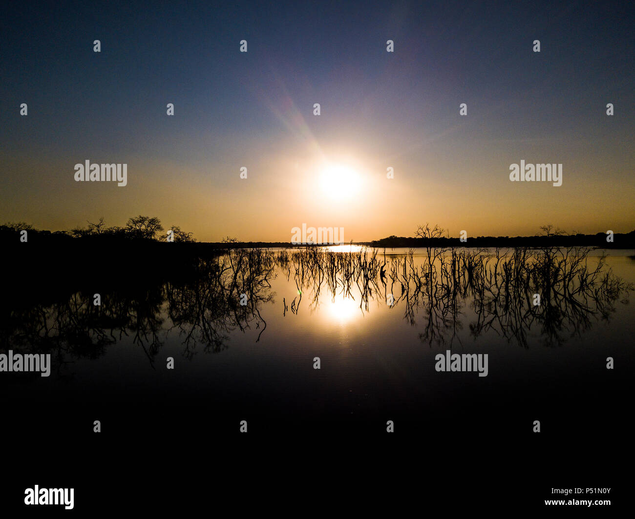 Sunset over a man-made dam in Kalumbila Zambia Stock Photo - Alamy